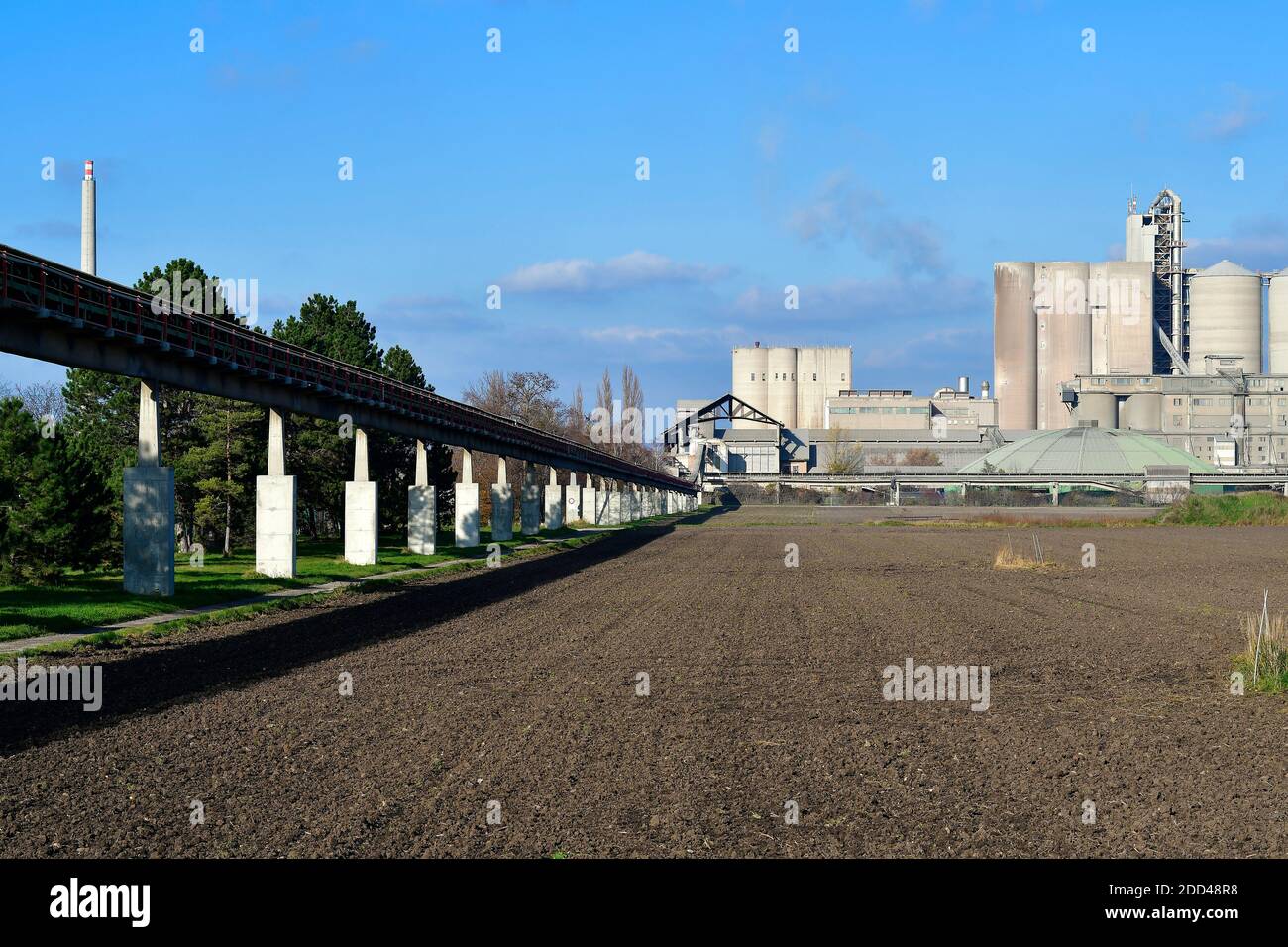 Austria, cement factory with conveyor belt and farmland in Lower ...