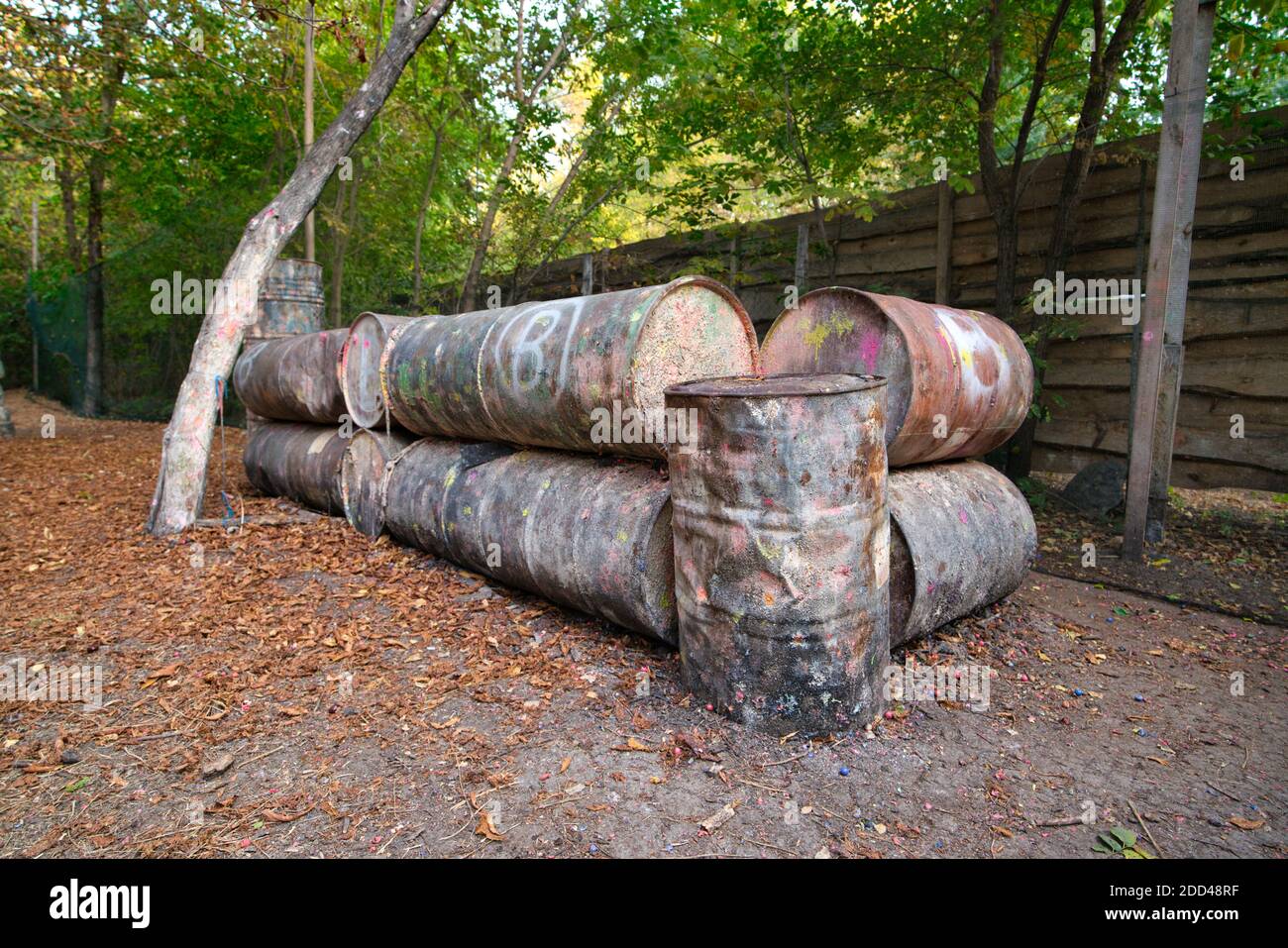 Lots of old round barrels in the paintball base Stock Photo - Alamy
