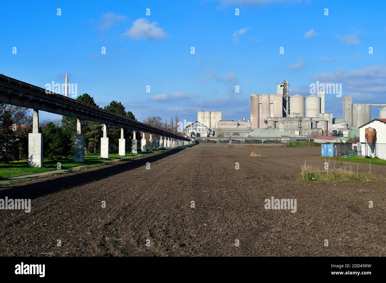 Austria, cement factory with conveyor belt and farmland in Lower ...