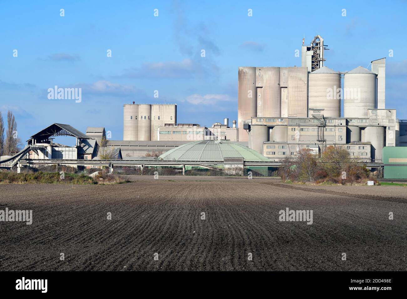 Austria, cement factory with conveyor belt and farmland in Lower ...