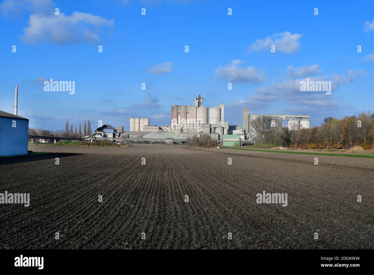 Austria, cement factory with conveyor belt and farmland in Lower ...