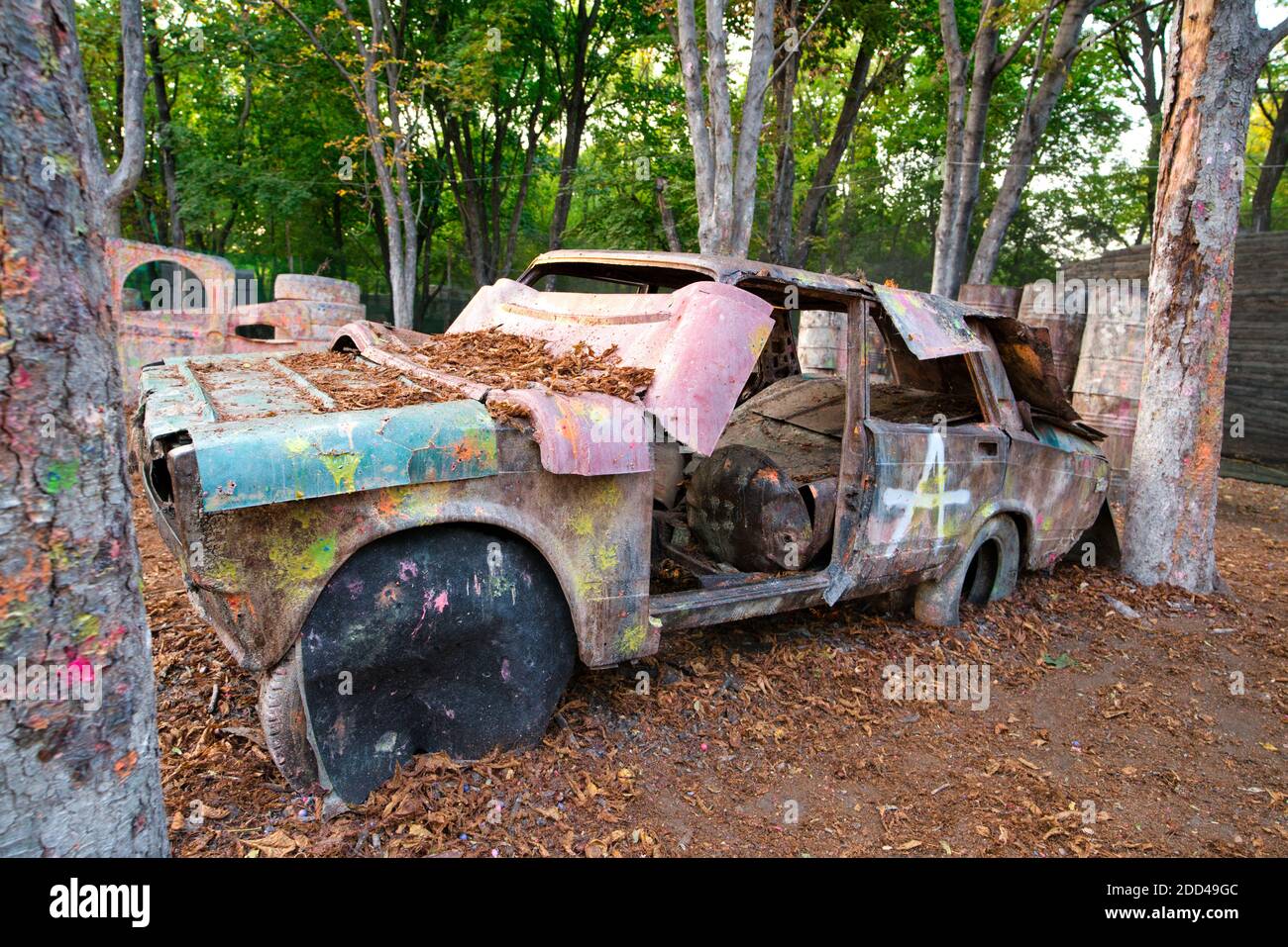 Old rusty and abandoned car at the paintball base Stock Photo - Alamy