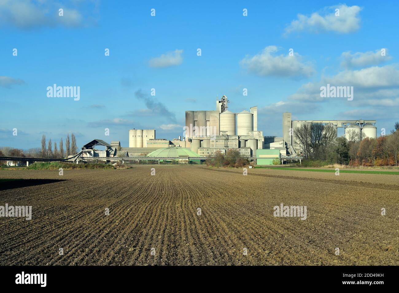 Austria, cement factory with conveyor belt and farmland in Lower ...