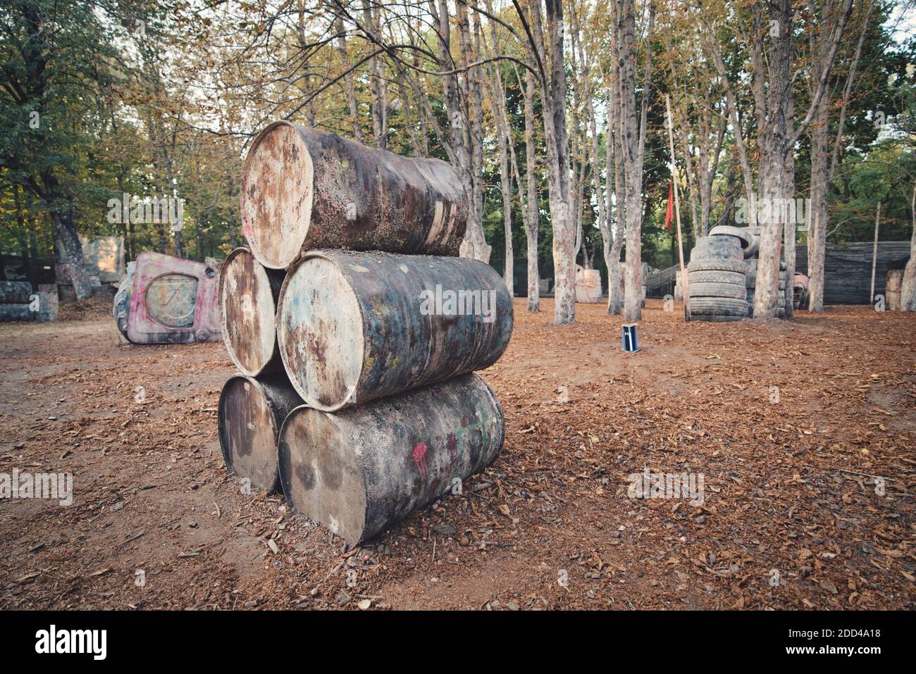 Lots of old round barrels in the paintball base Stock Photo - Alamy