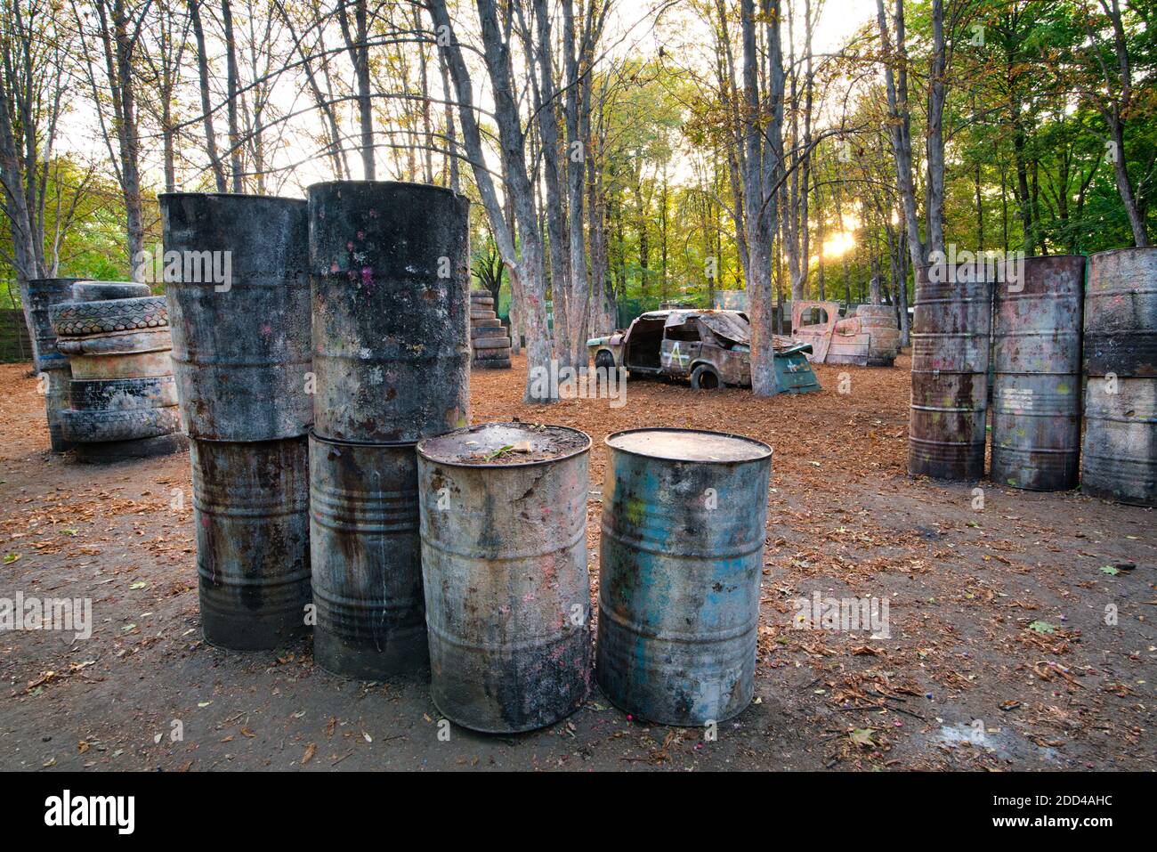 Lots of old round barrels in the paintball base Stock Photo - Alamy