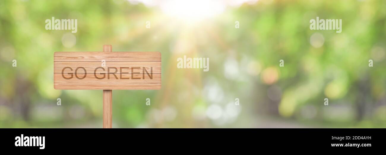 Environment concept. wooden sign with word Go Green over green ...