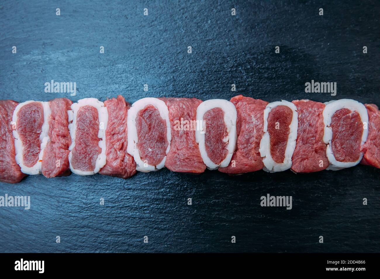 Skewers of fresh and raw shish kebab or barbecued shashlik meat.Raw and ...