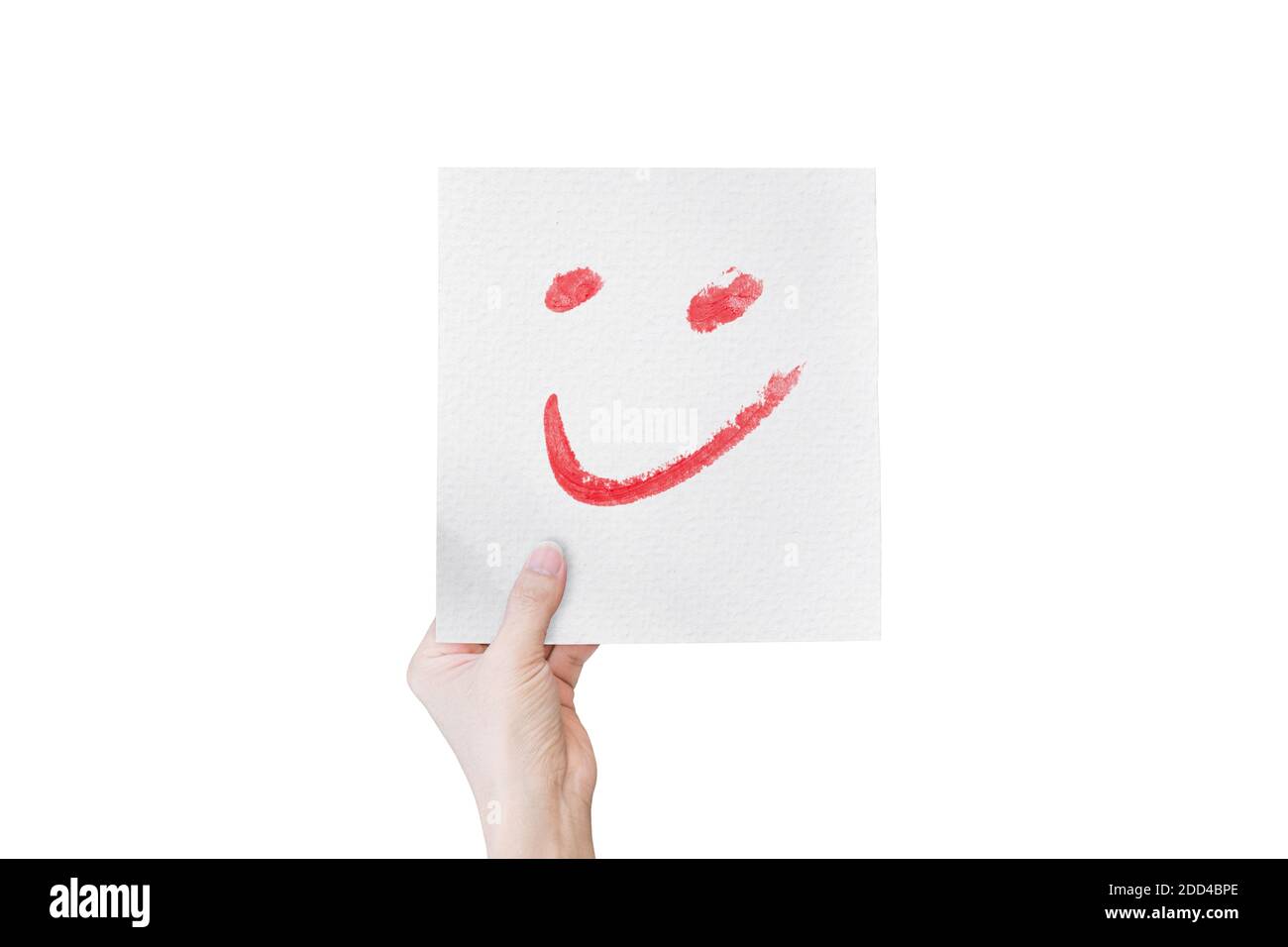Hand holding white paper with hand drawn smiley face emoticons isolated ...