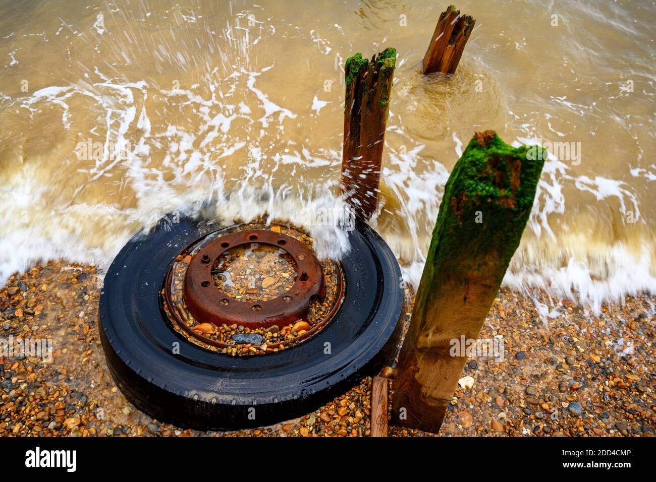 A lorry wheel with a deck chain washed up on a beach believed to be ...