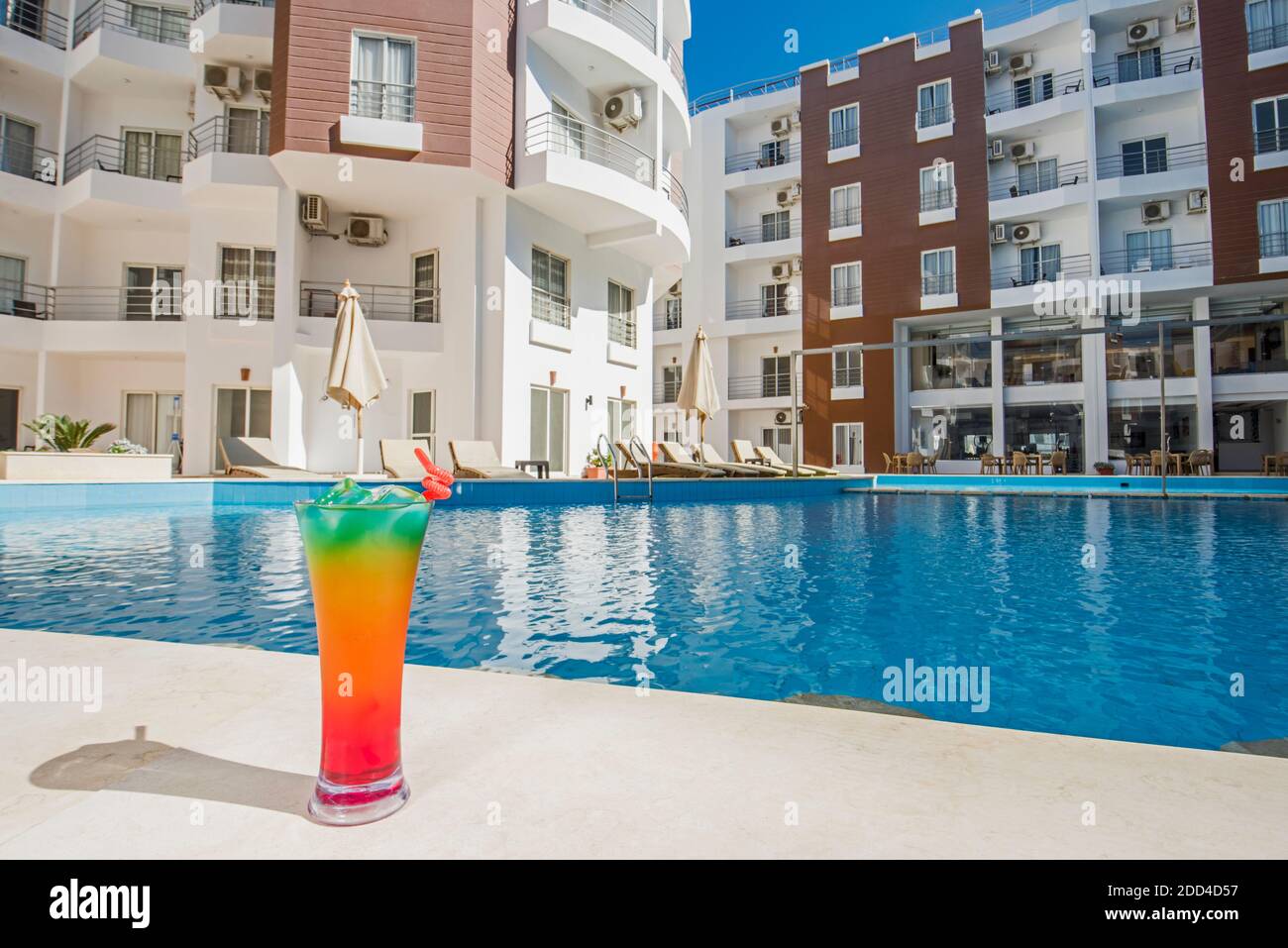 Large swimming pool with bar and cocktail drink at a luxury tropical ...