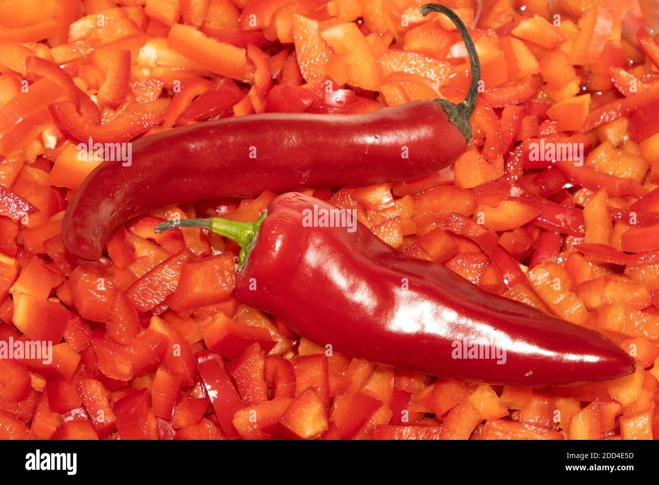 whole red chilli laid over chopped chilli background Stock Photo - Alamy
