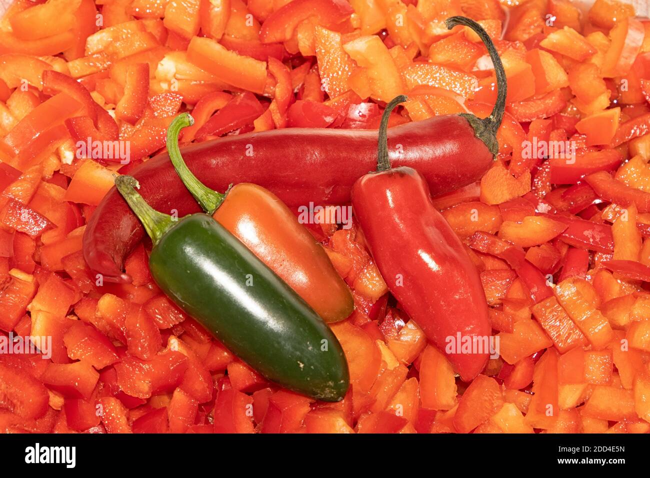whole red chilli laid over chopped chilli background Stock Photo - Alamy