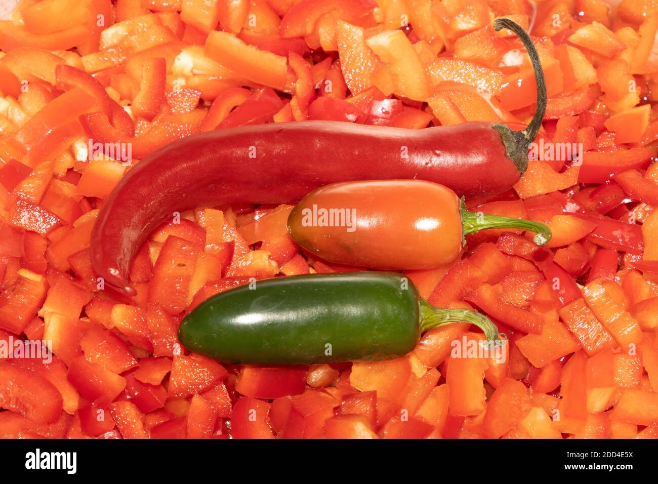 whole red chilli laid over chopped chilli background Stock Photo - Alamy