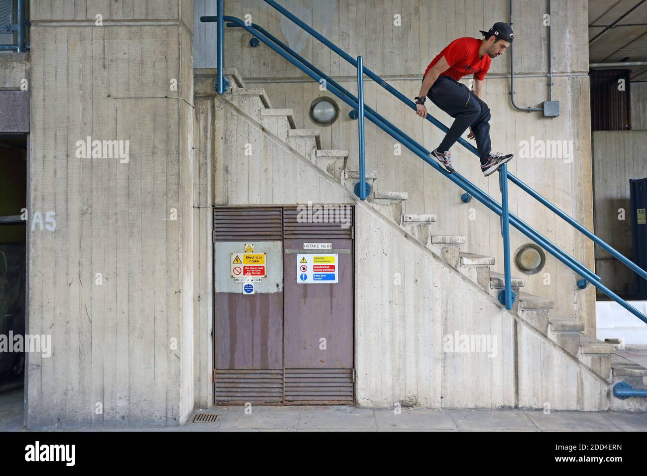 Free runner practicing parkour at housing estate in London , United ...