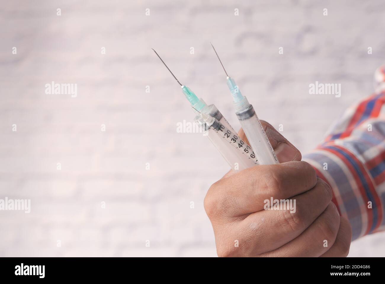 hand holding many syringe with copy space Stock Photo - Alamy