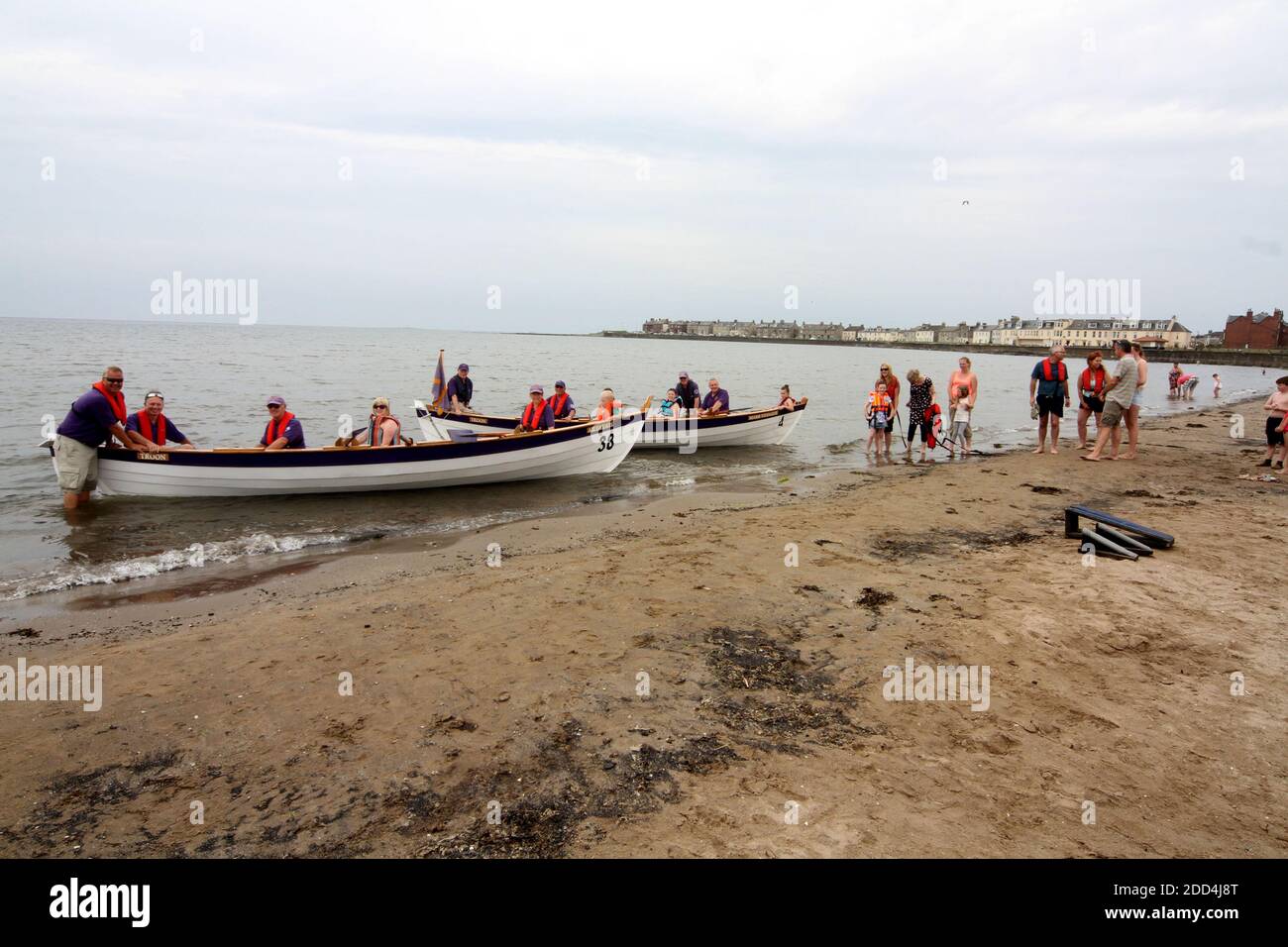 Troon Beach, Ayr, Ayrshire, Scotland. Members ot Troon Rowing Club in ...