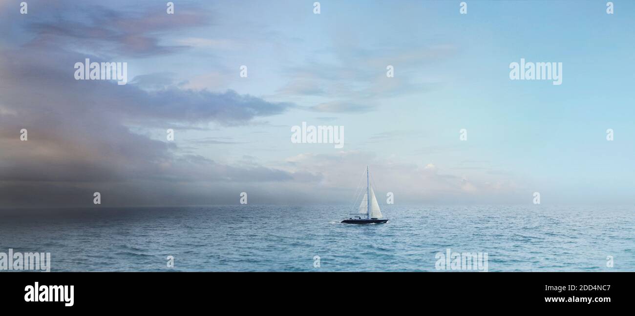 Yacht sailing from bad, cloudy weather into clear sky Stock Photo - Alamy