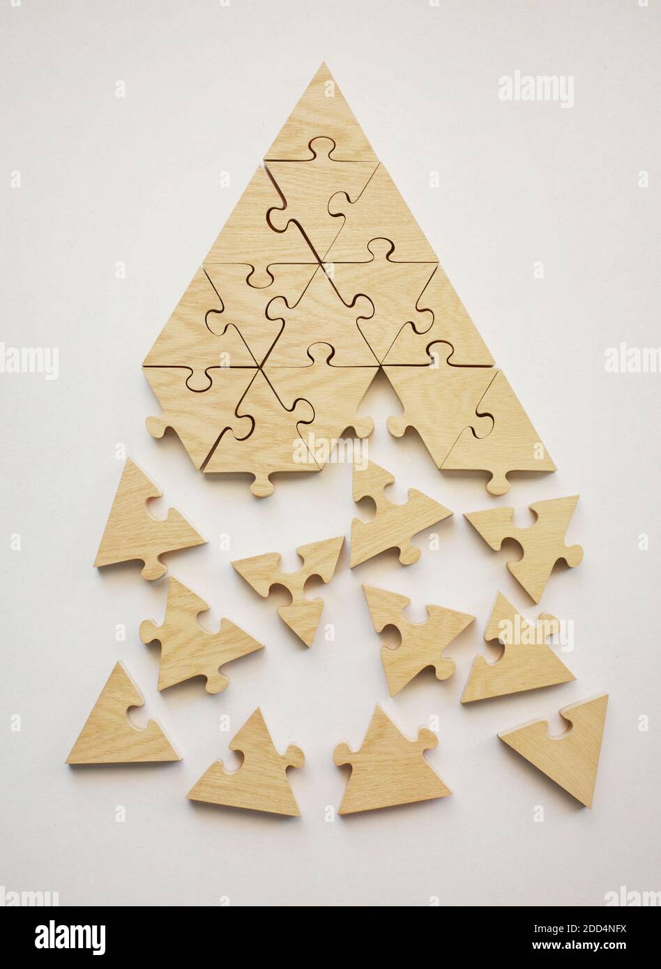 Triangle shaped wooden puzzle incomplete Stock Photo - Alamy