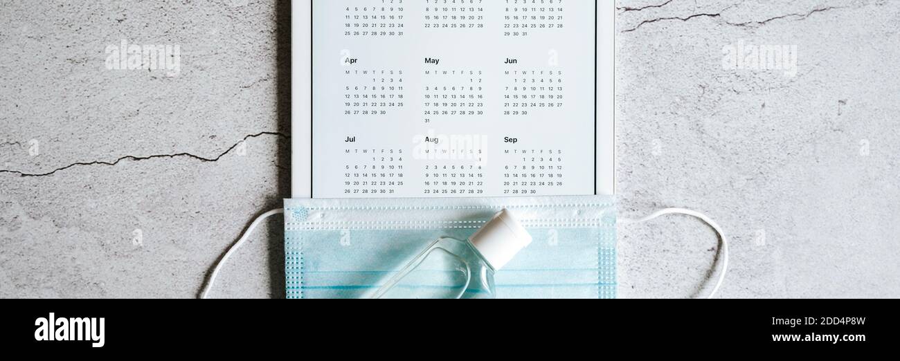 a tablet with an open calendar for 2021 year and protective medical ...
