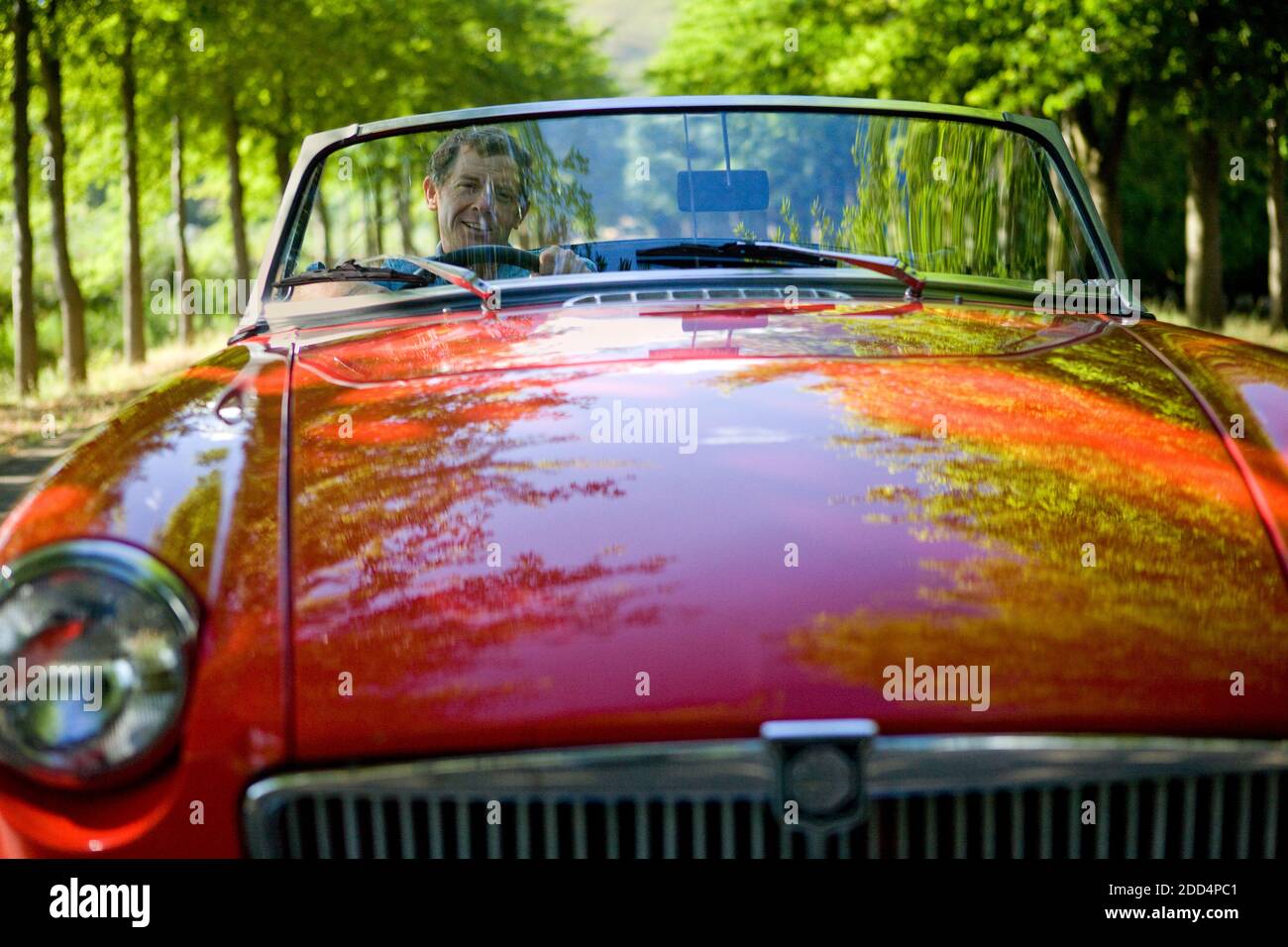 Man driving red cabriolet hi-res stock photography and images - Alamy