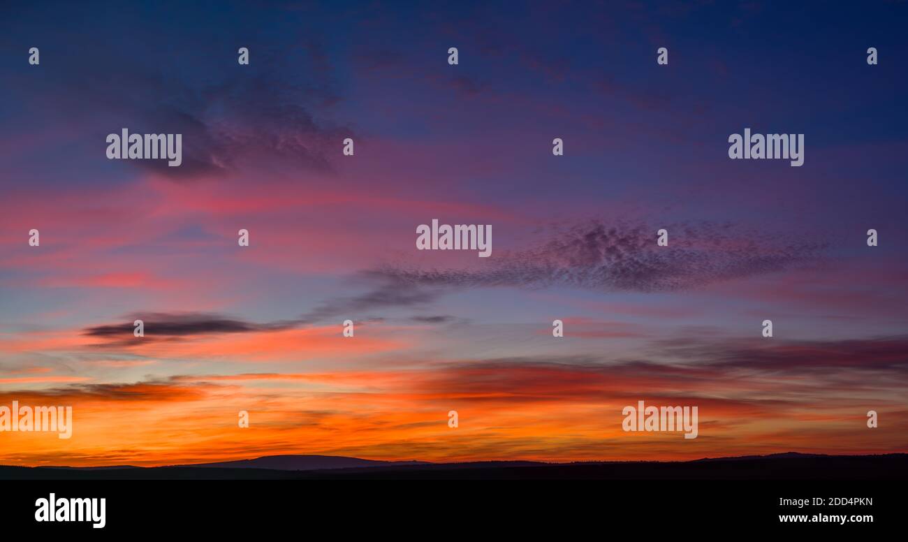 very colorful red, blue, orange and violet late sunset Stock Photo - Alamy