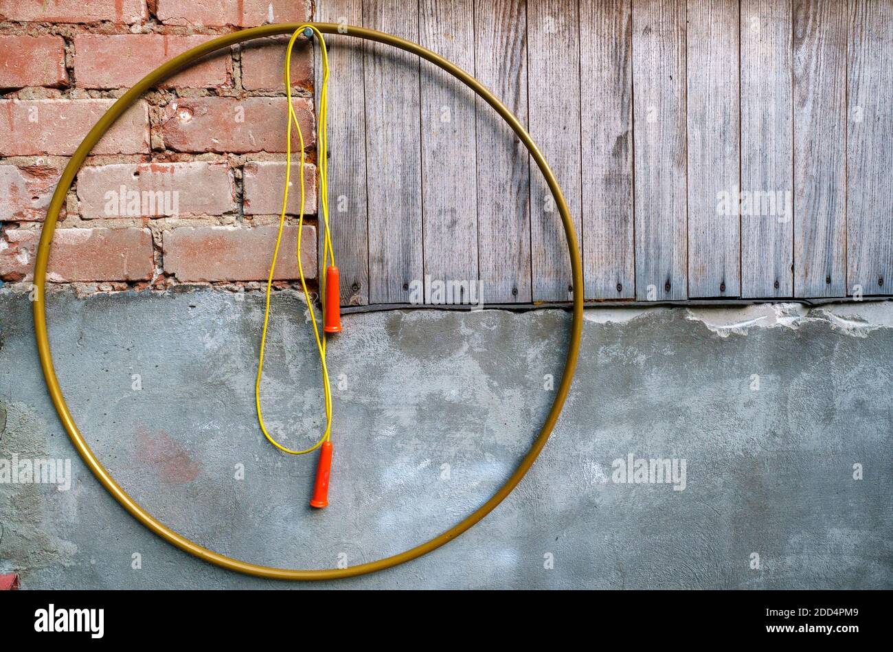 Hoop and skipping rope hanging on wall Stock Photo - Alamy