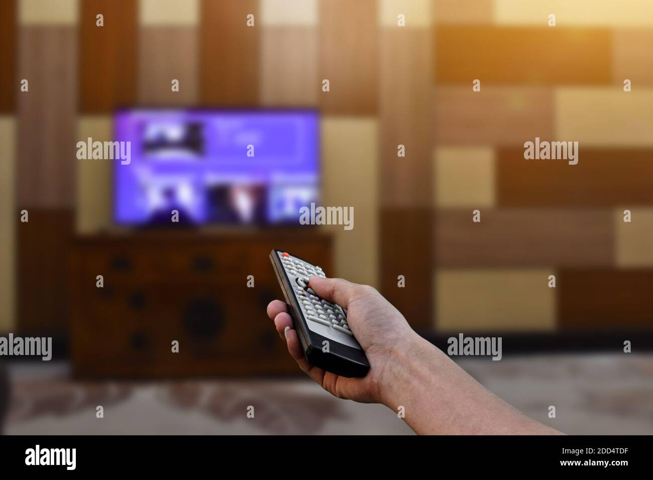 Close up hand holding remote control a television. Selective focus ...