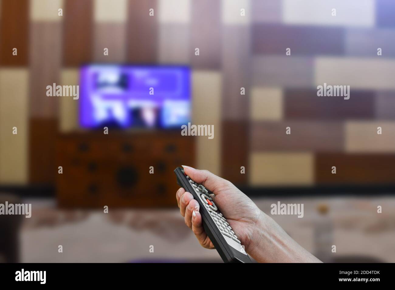 Close up hand holding remote control a television. Selective focus ...