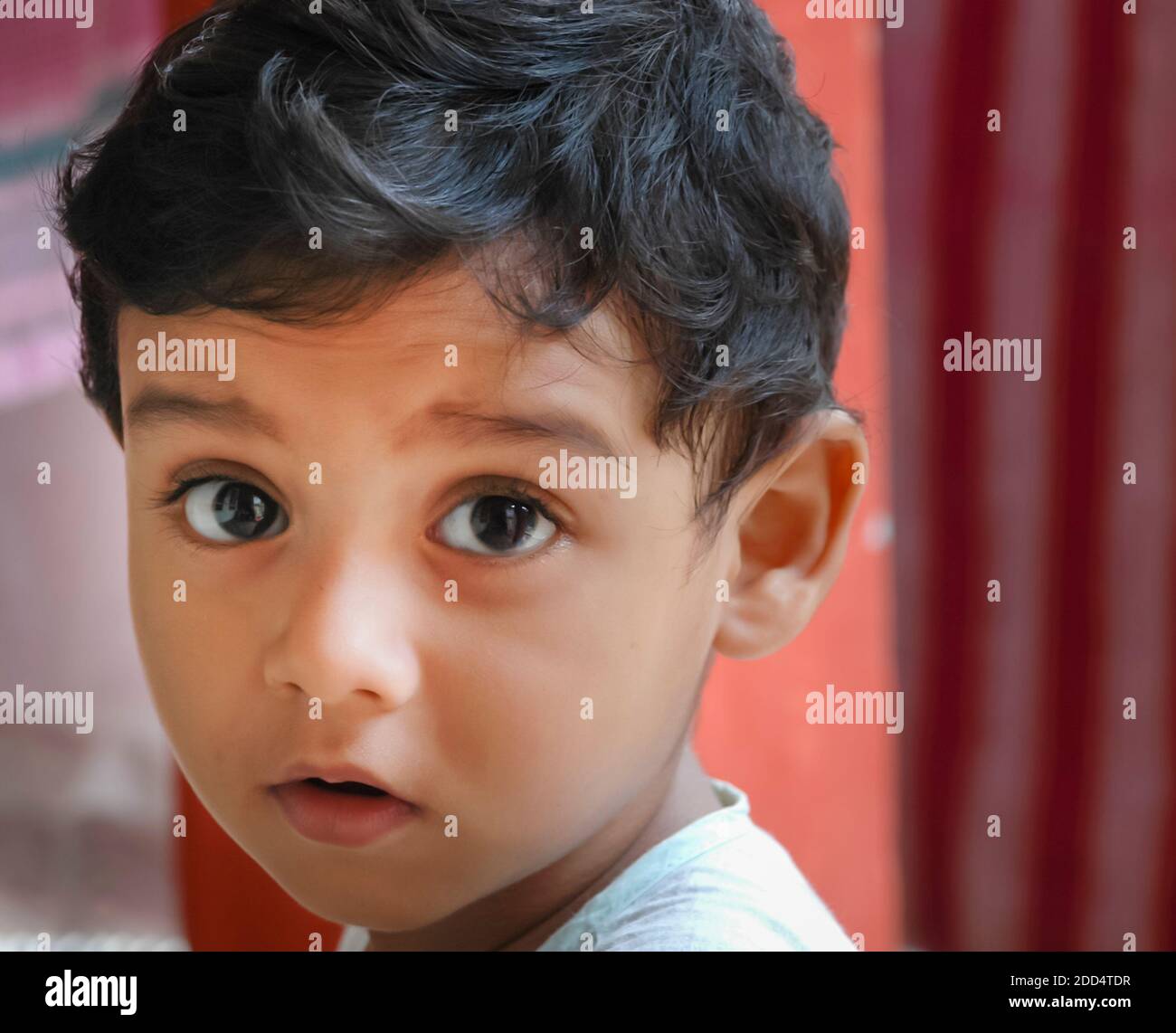 An Asian Indian baby with raised eyebrows looking at the camera Stock ...