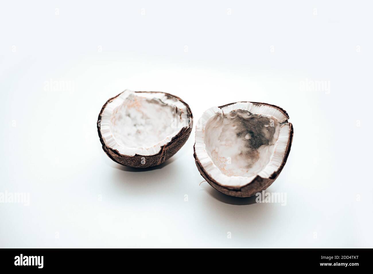 Two halves of coconut spoiled by mold isolated on white background ...