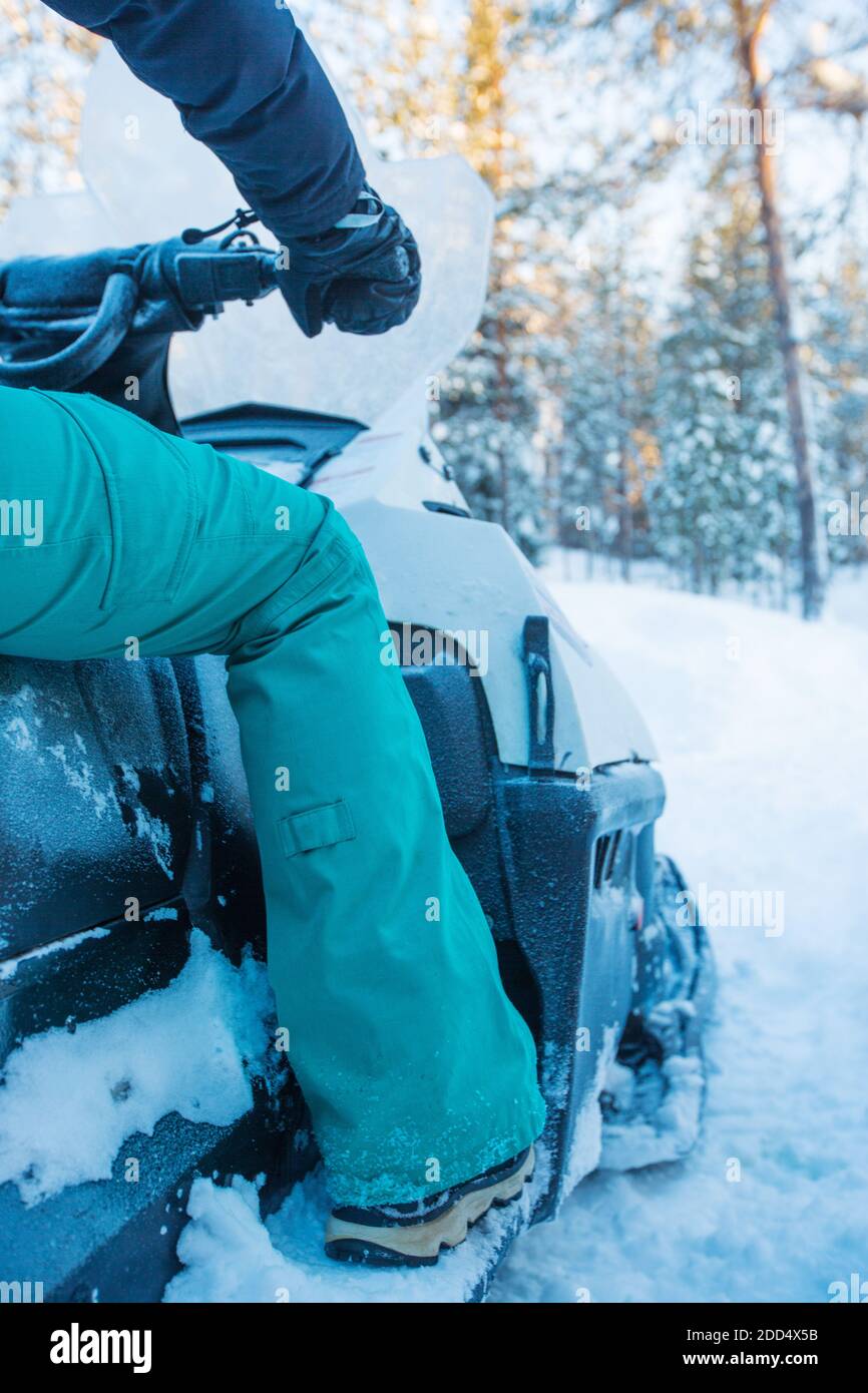 Rider on the snowmobile in winter snow in the morning side view ...