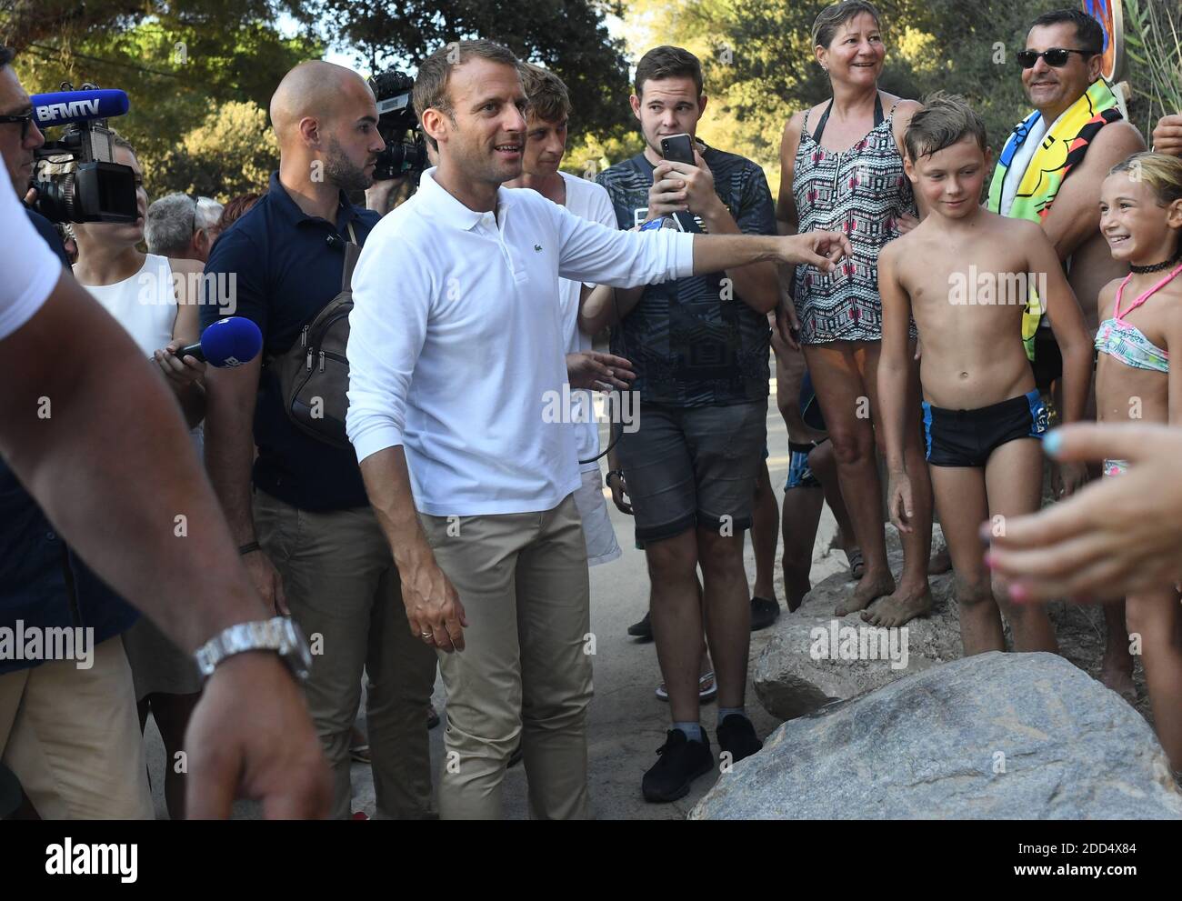 French President Emmanuel Macron poses as he meet people during a walk ...