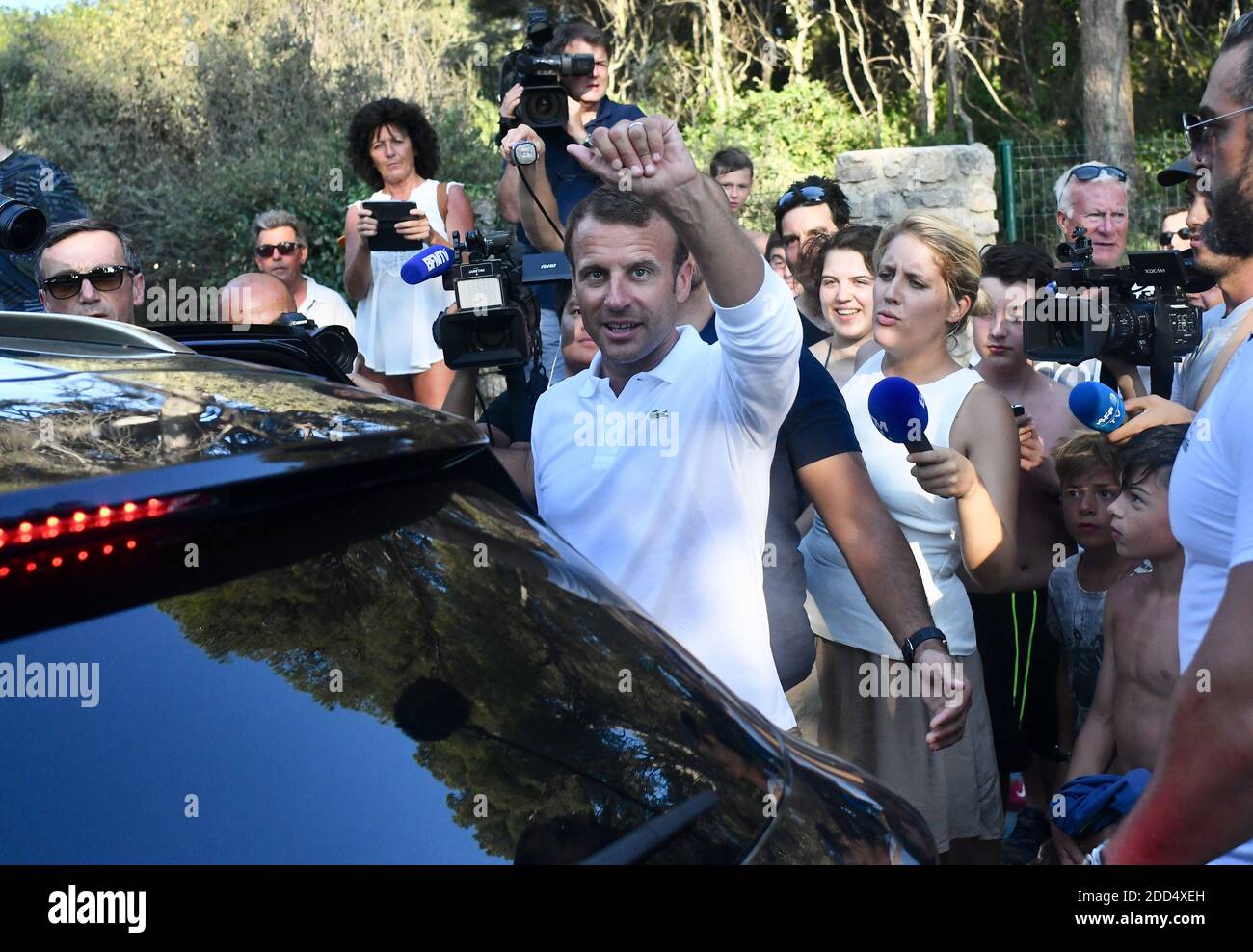 French President Emmanuel Macron poses as he meet people during a walk ...