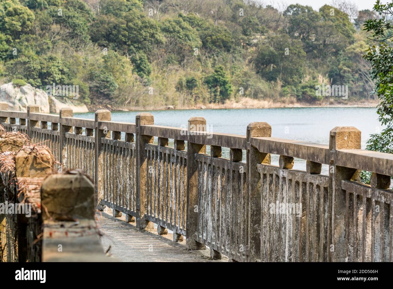 Chinese traditional bridge next to lake in the Putuoshan mountains ...