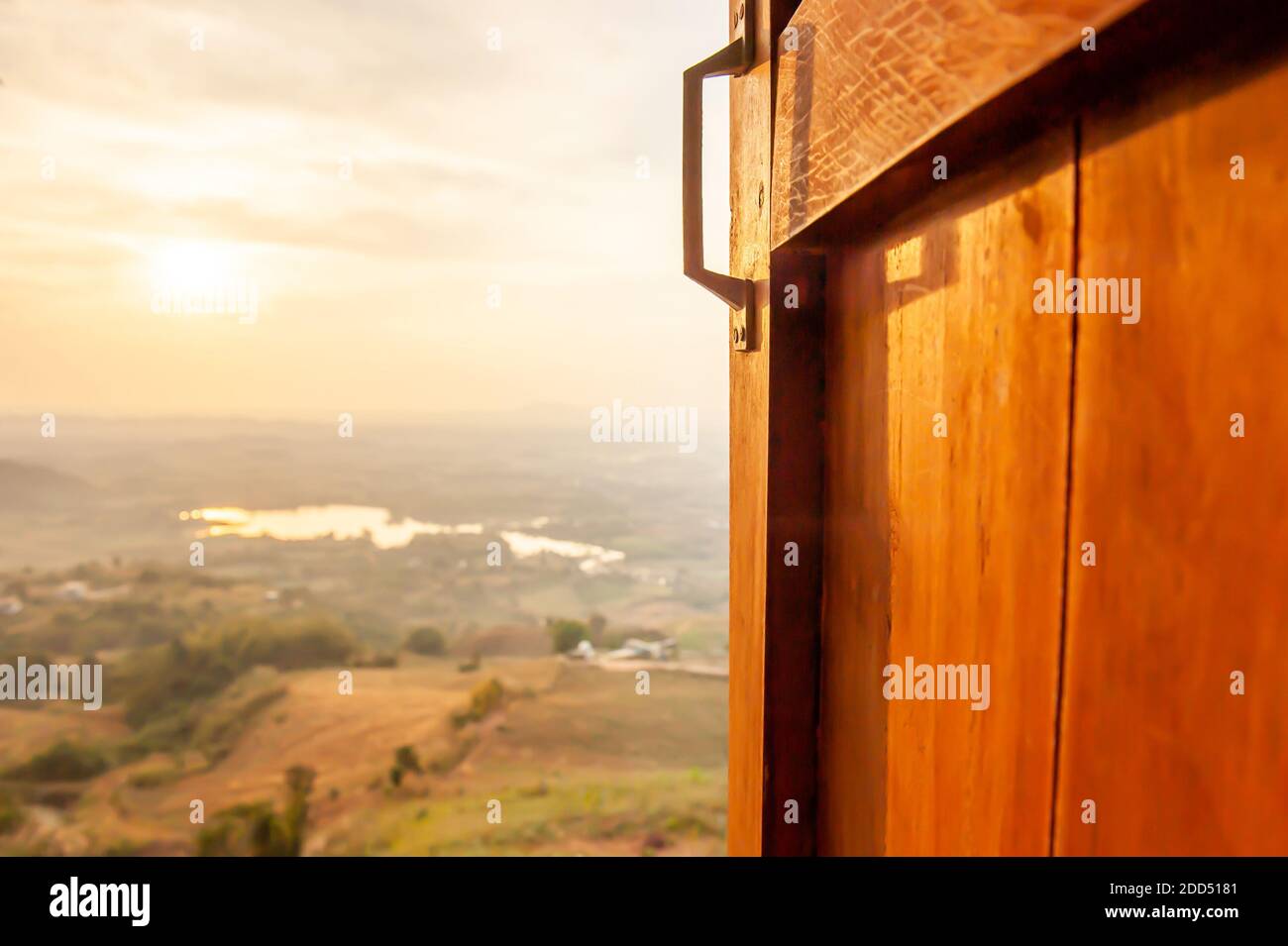 Open window view onto a tranquil morning with the sun shines on a lake ...