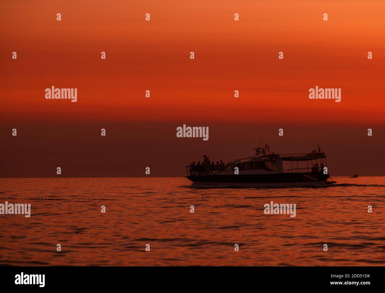 Touristic boat on open sea at beautiful golden sunset. Istria region ...