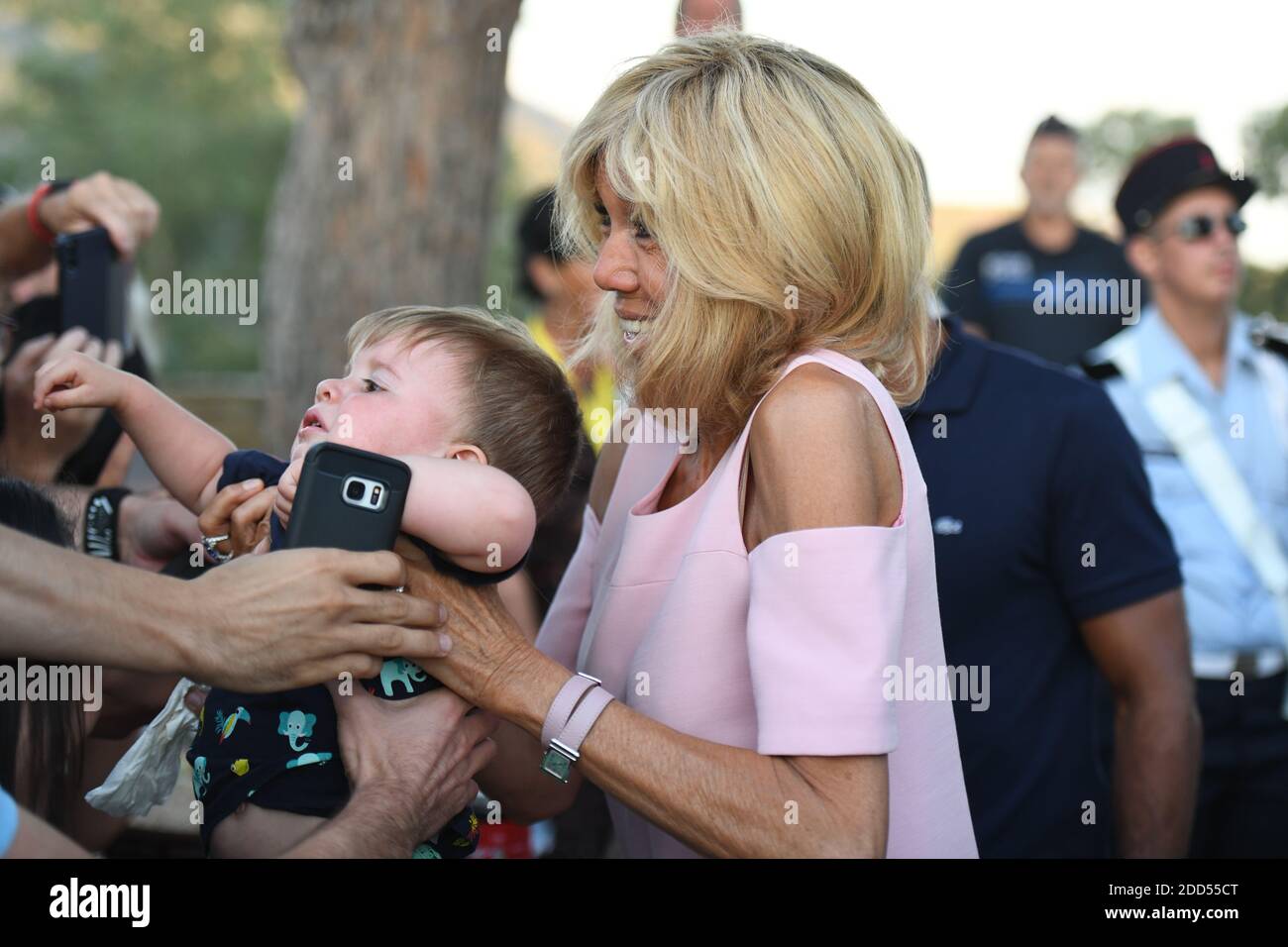 Brigitte Macron is carrying a little boy after marking the 74th ...