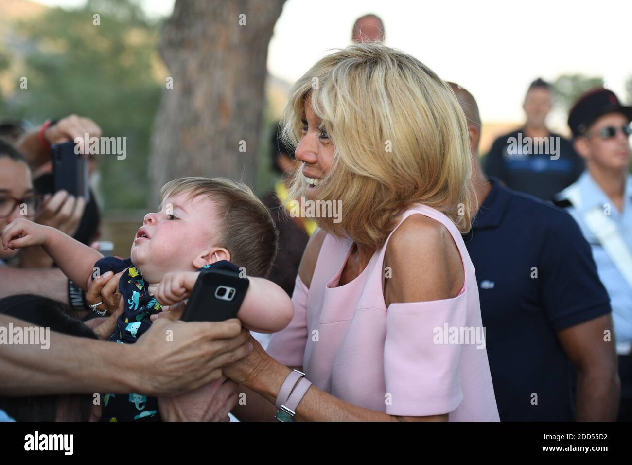 Brigitte Macron is carrying a little boy after marking the 74th ...