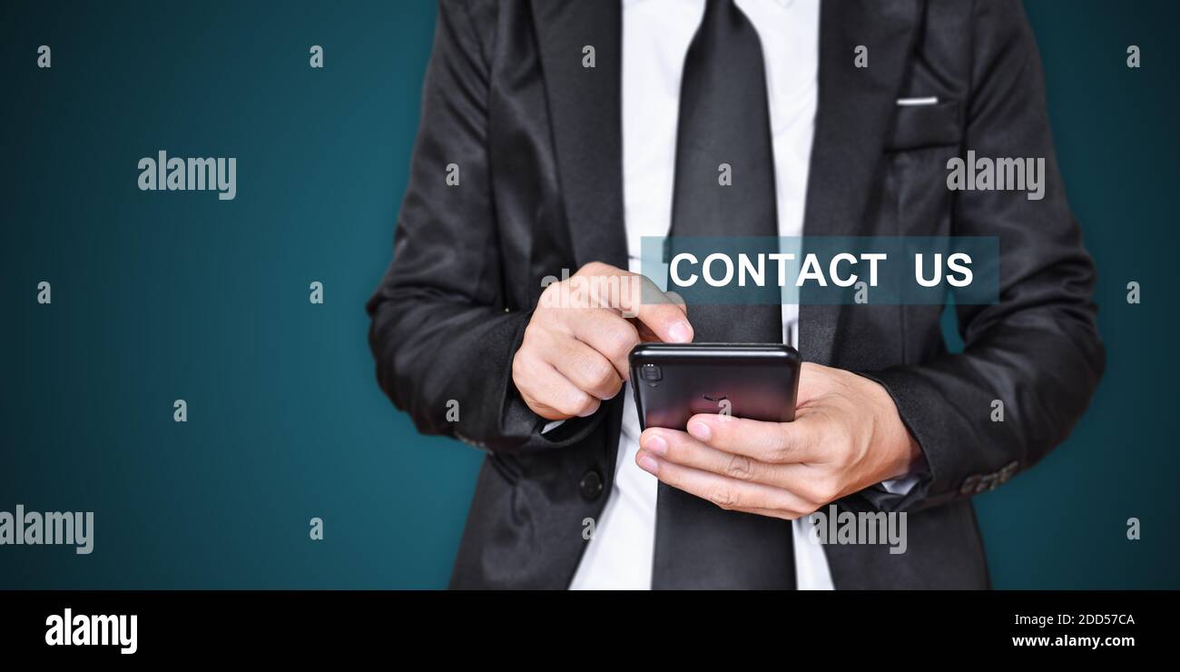 CONTACT US. Businessman hand using mobile phone. Communication concept ...