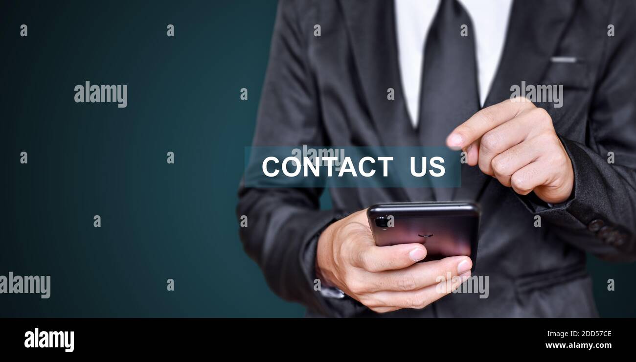 CONTACT US. Businessman hand using mobile phone. Communication concept ...