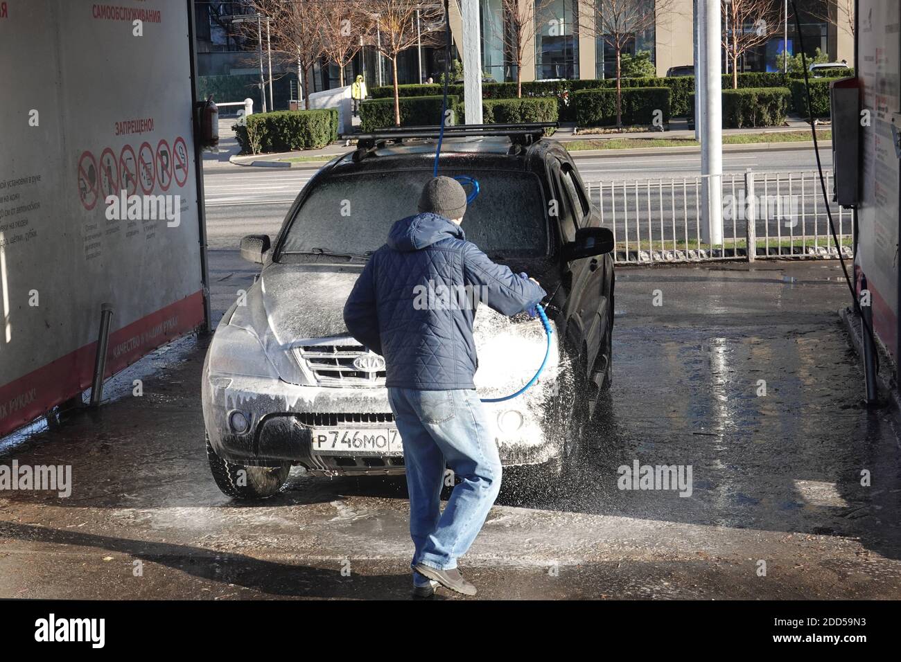 Driver washing car at self-service car wash Stock Photo - Alamy