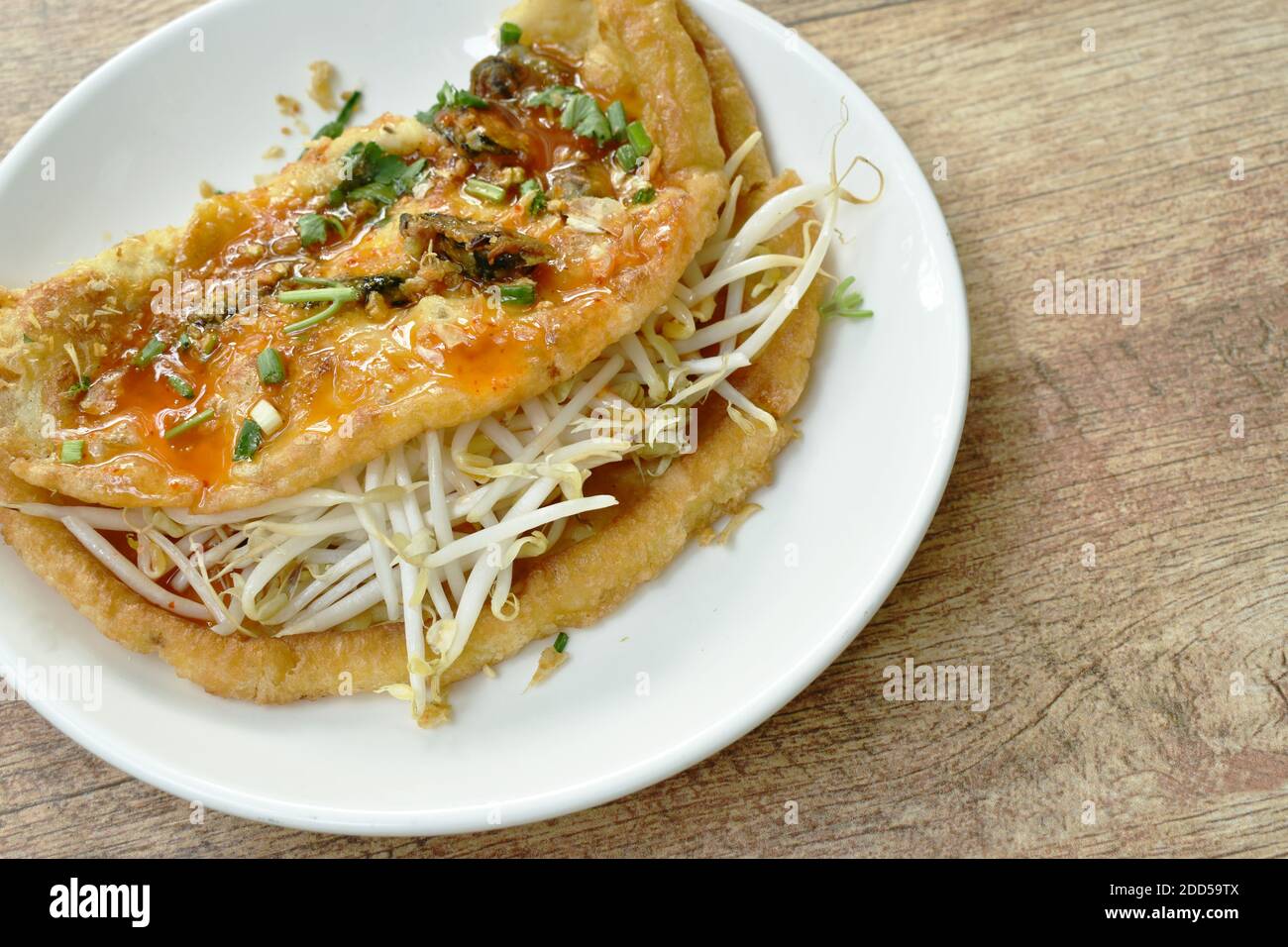 fried egg stuffed mussel with bean sprout topping garlic and dressing ...