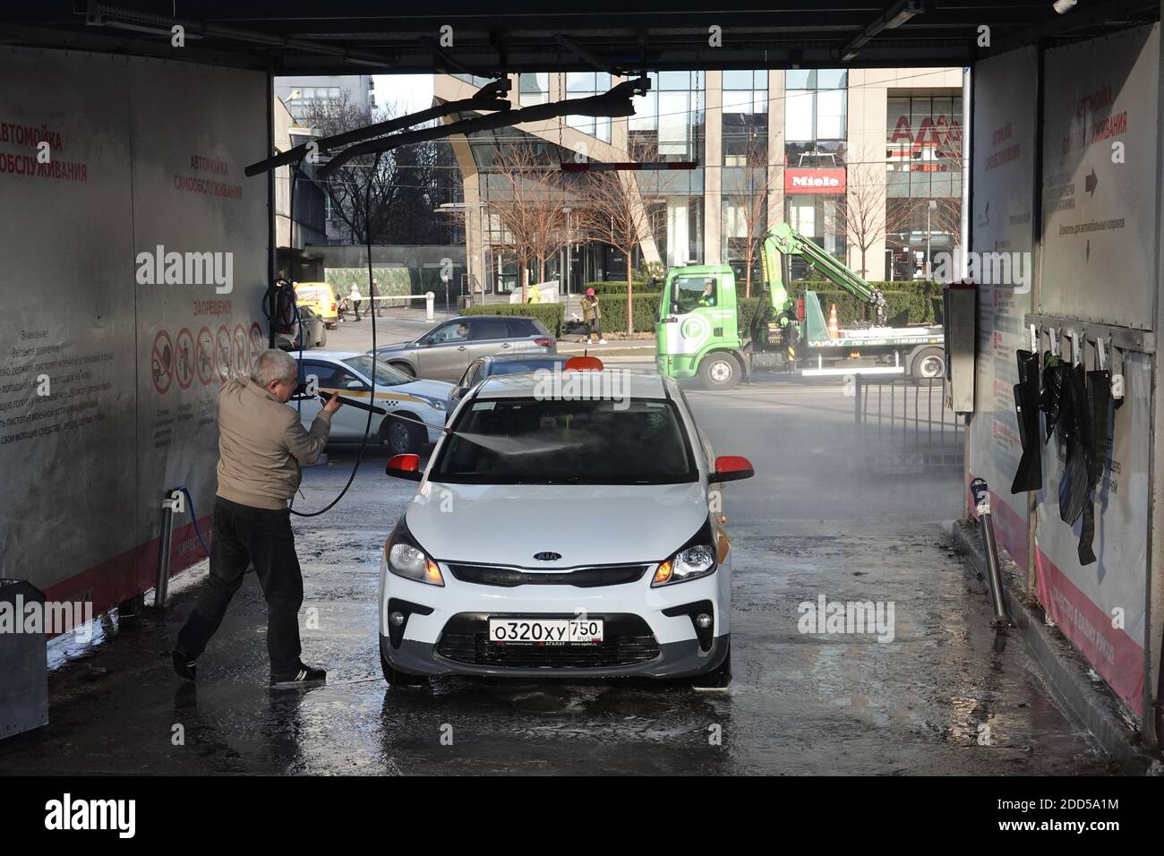Driver washing car at self-service car wash Stock Photo - Alamy