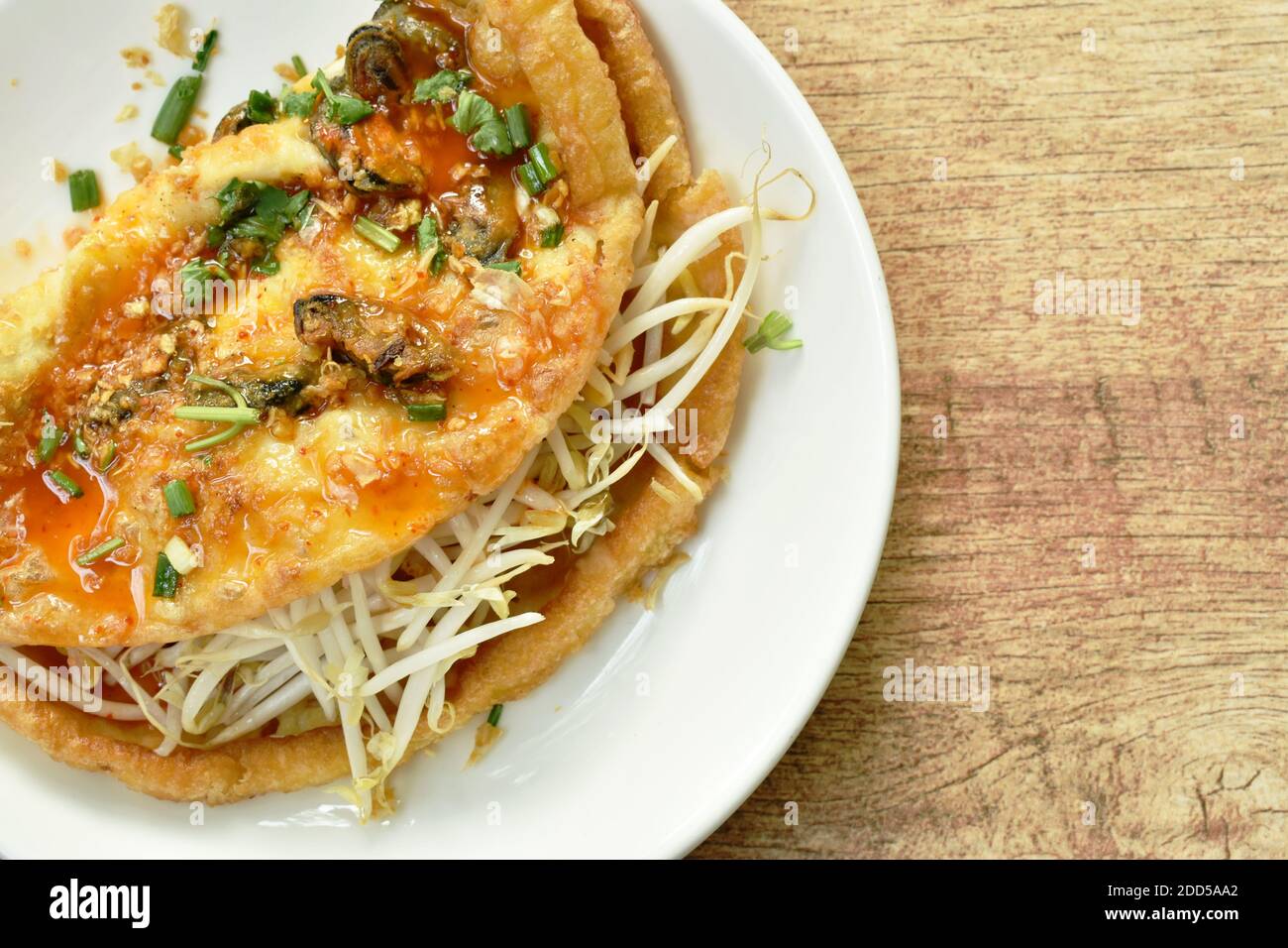 fried egg stuffed mussel with bean sprout topping garlic and dressing ...