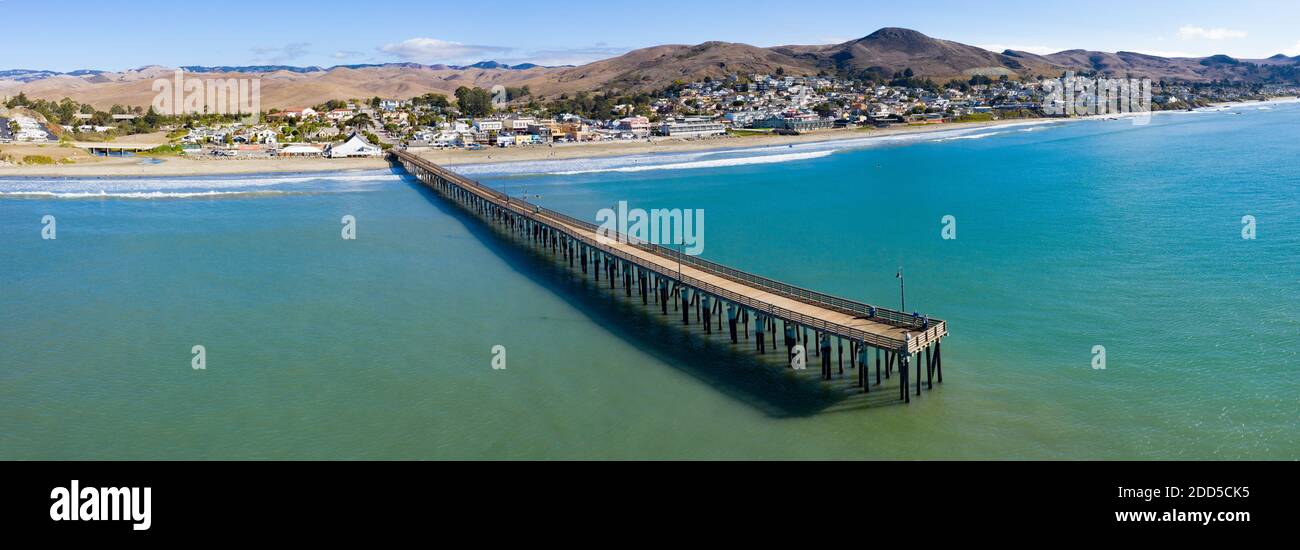 A long pier reaches out into the Pacific Coast in the quaint city of ...