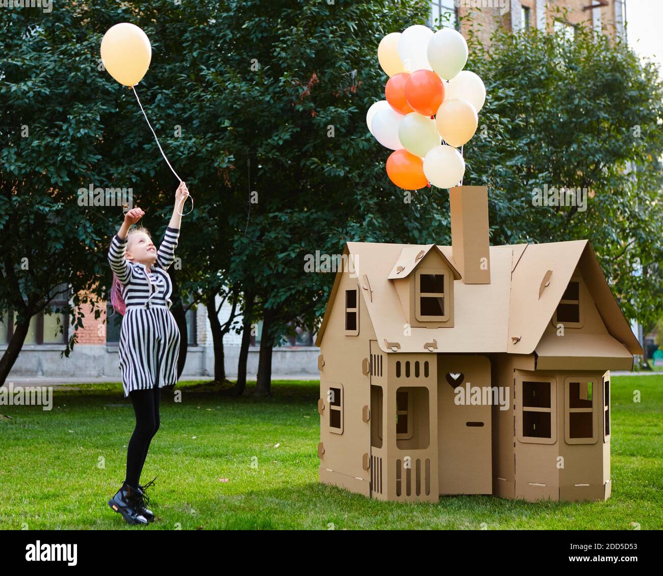 Child playing in a cardboard playhouse. Eco concept Stock Photo - Alamy