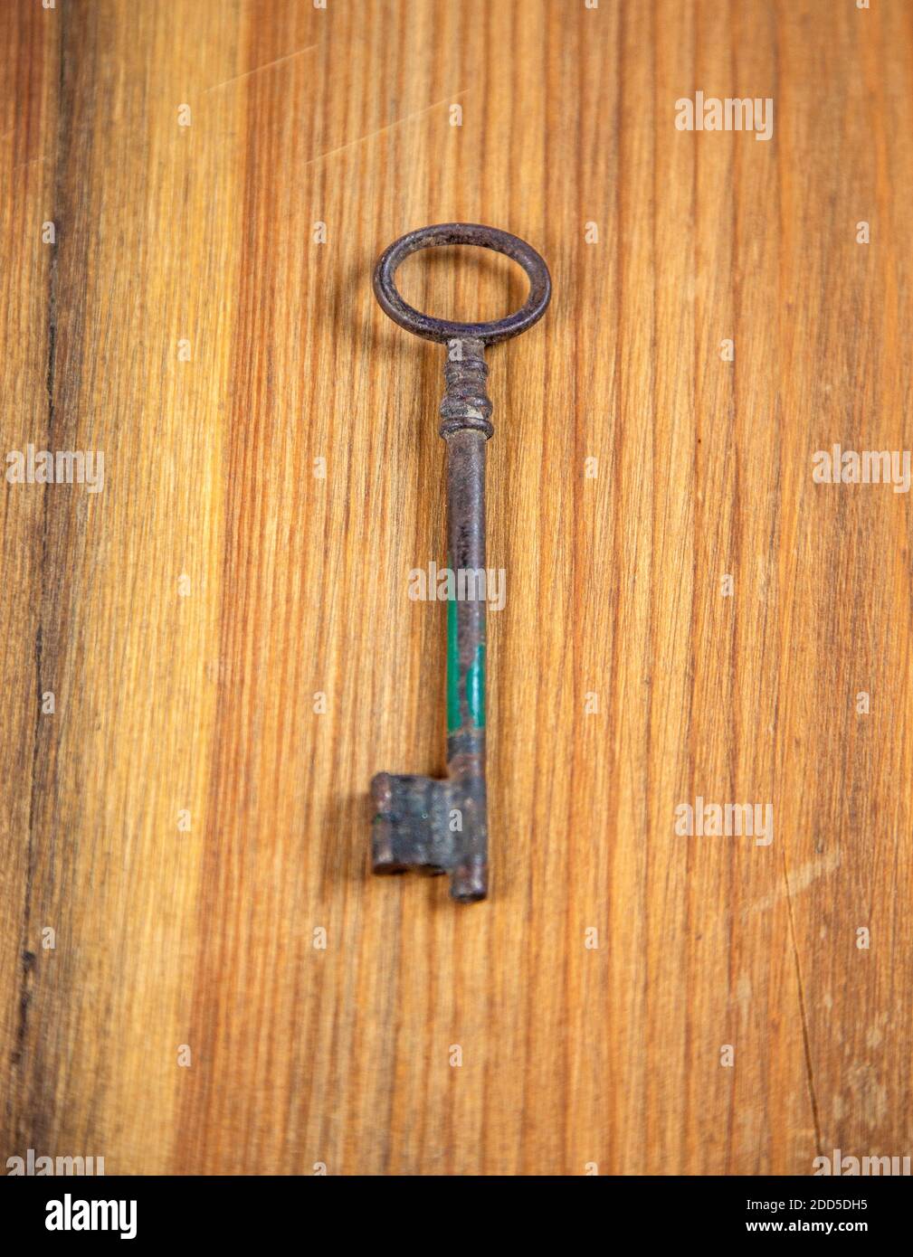 Old Rusted Door Key on natural wood Stock Photo - Alamy