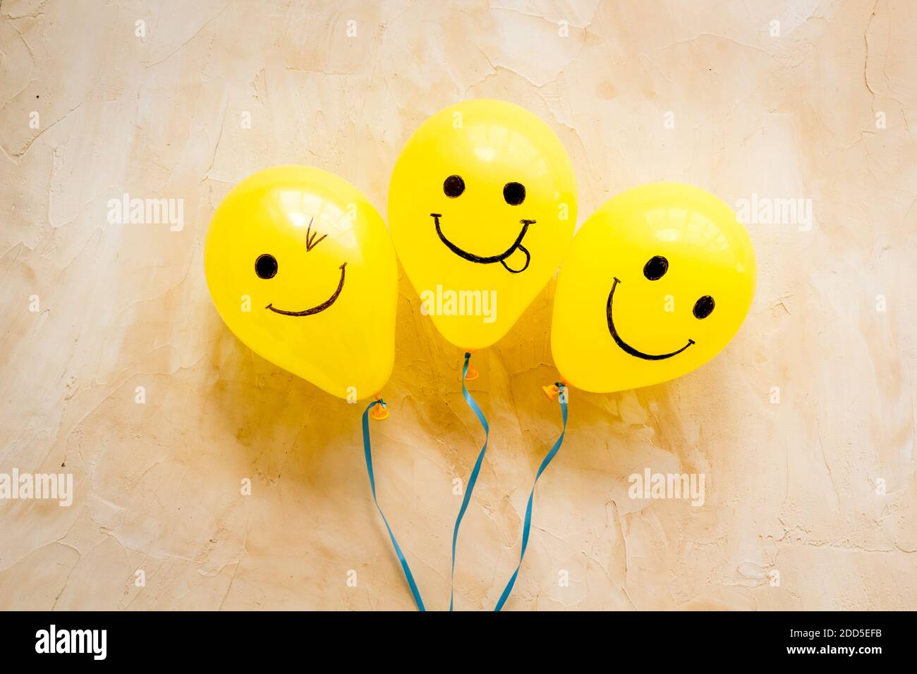 Positive emotions set. Happy and winking emoticons painted on colored ...
