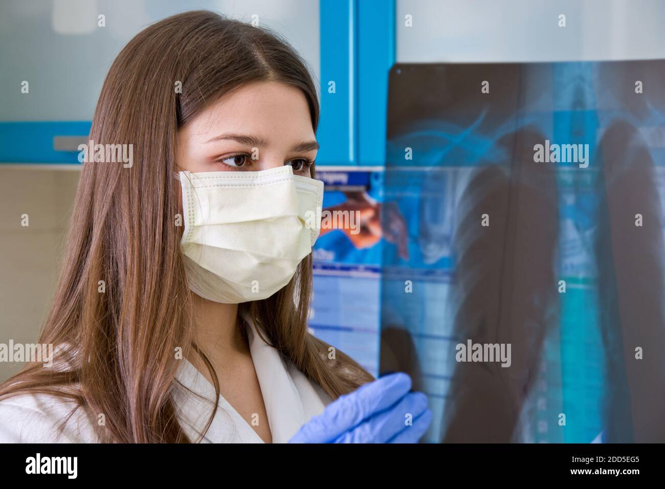 Female doctor in face mask looks at the x-ray of the lungs Stock Photo ...