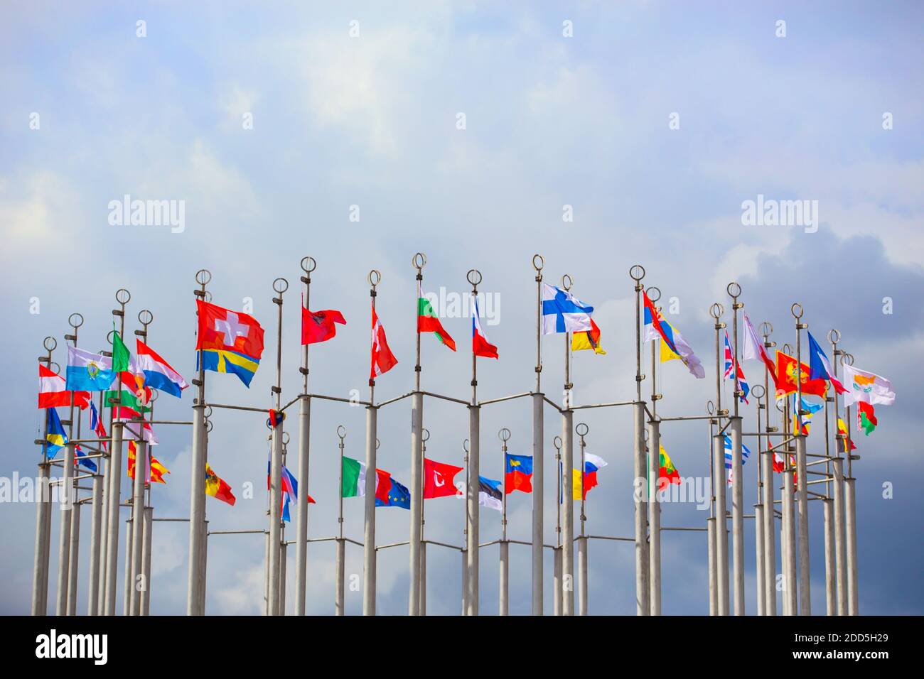 Flags of European states on flagpoles against blue sky background Stock ...